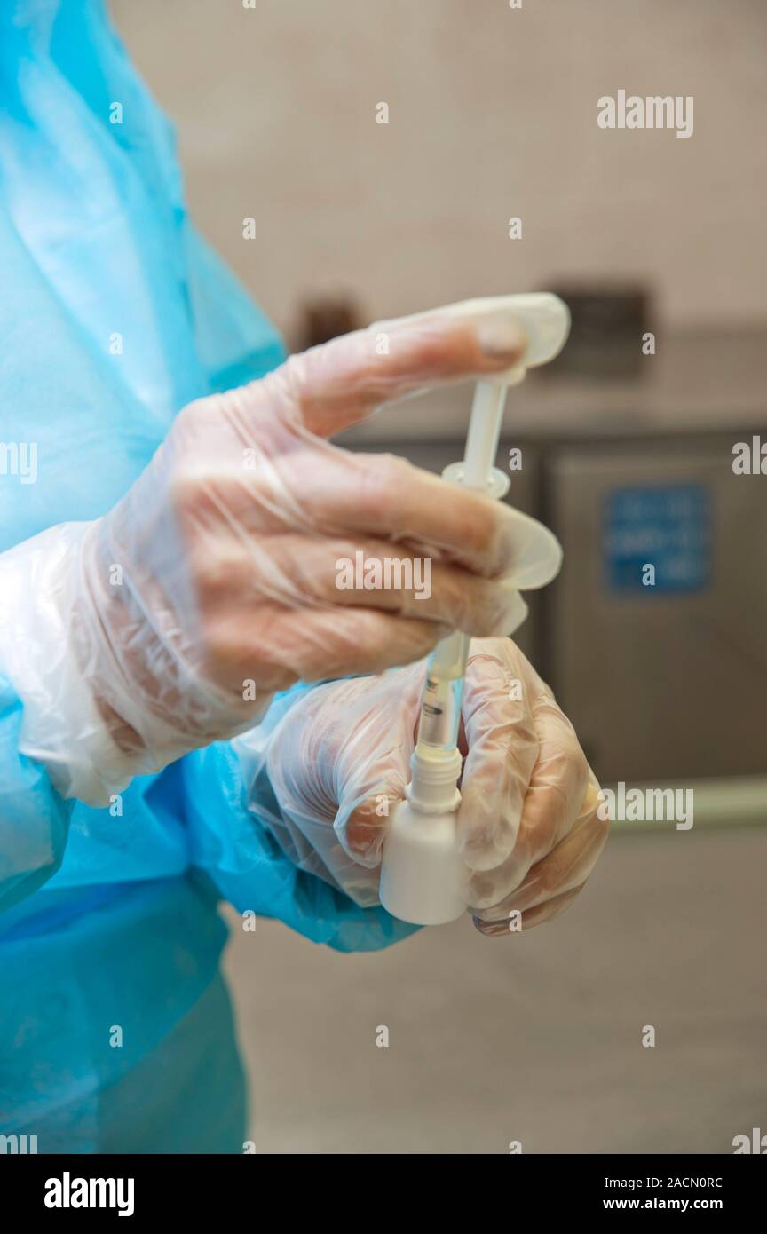 Lab technician with gloves and protective clothing Stock Photo - Alamy