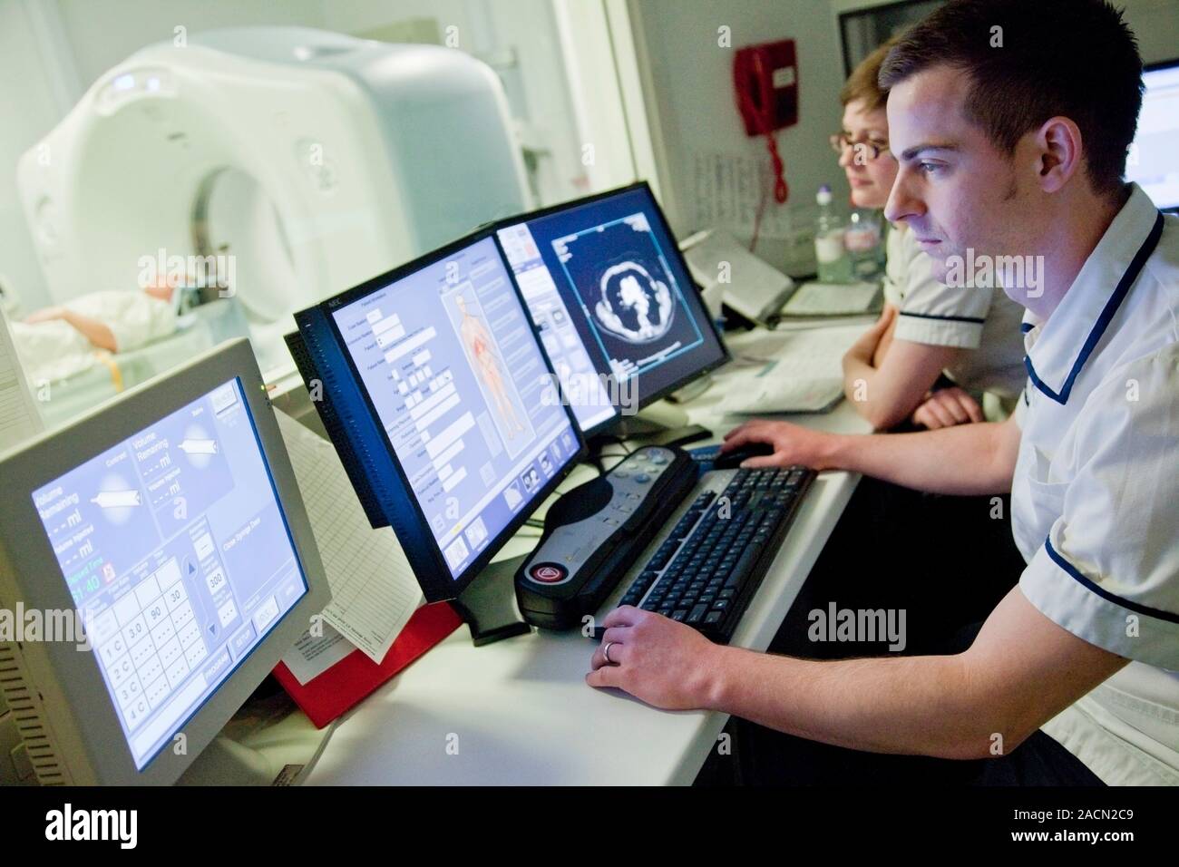 CT scanning. Woman patient under- goes a CT (Computed Tomography or CAT ...