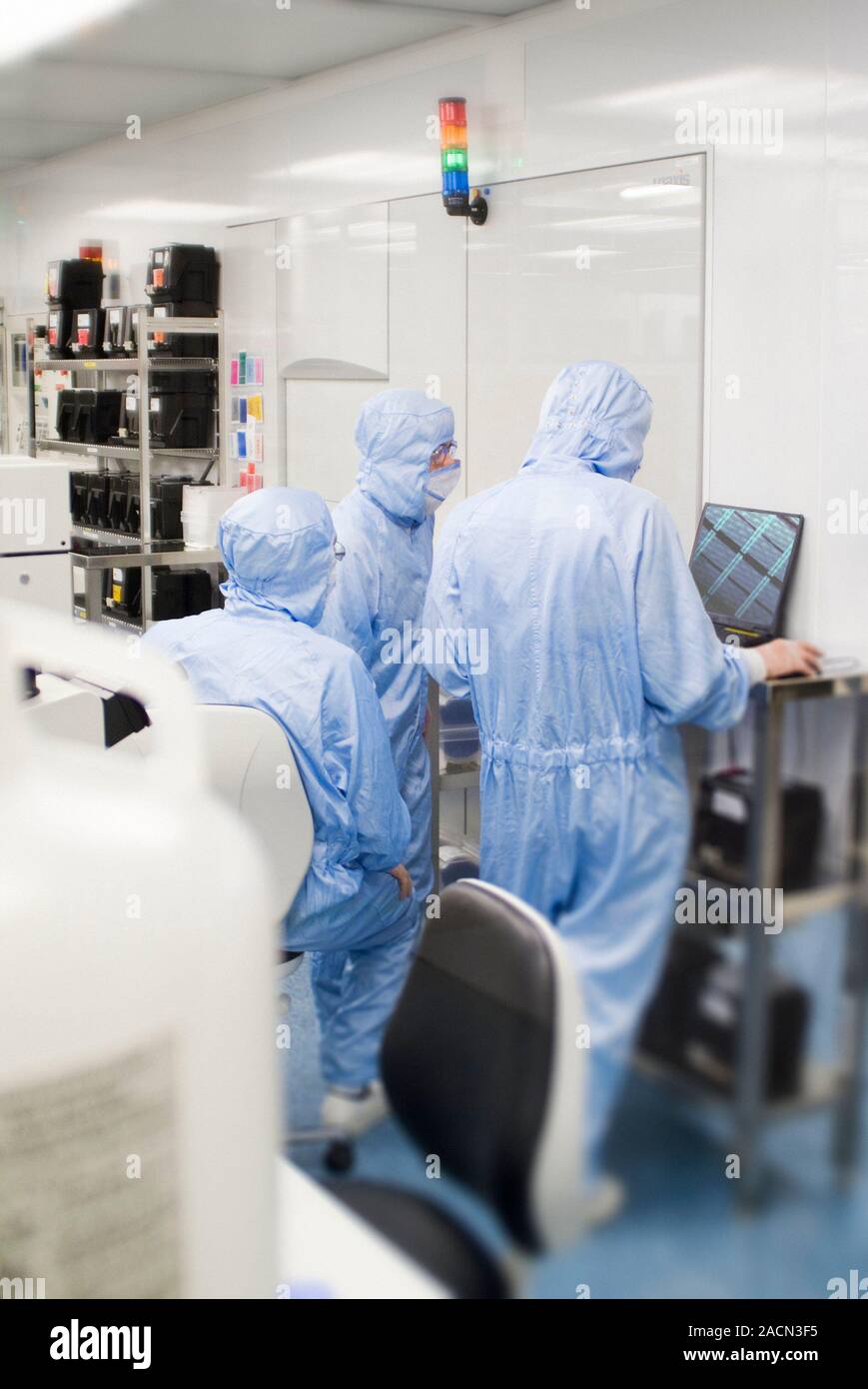 MEMS factory. Workers in a cleanroom at a factory that makes MEMS ...