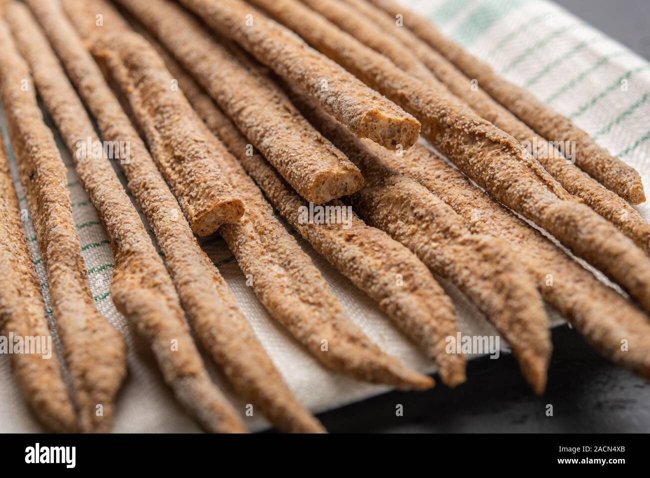 Italian traditional rye bread grissini on linen napkin. Close up Stock ...