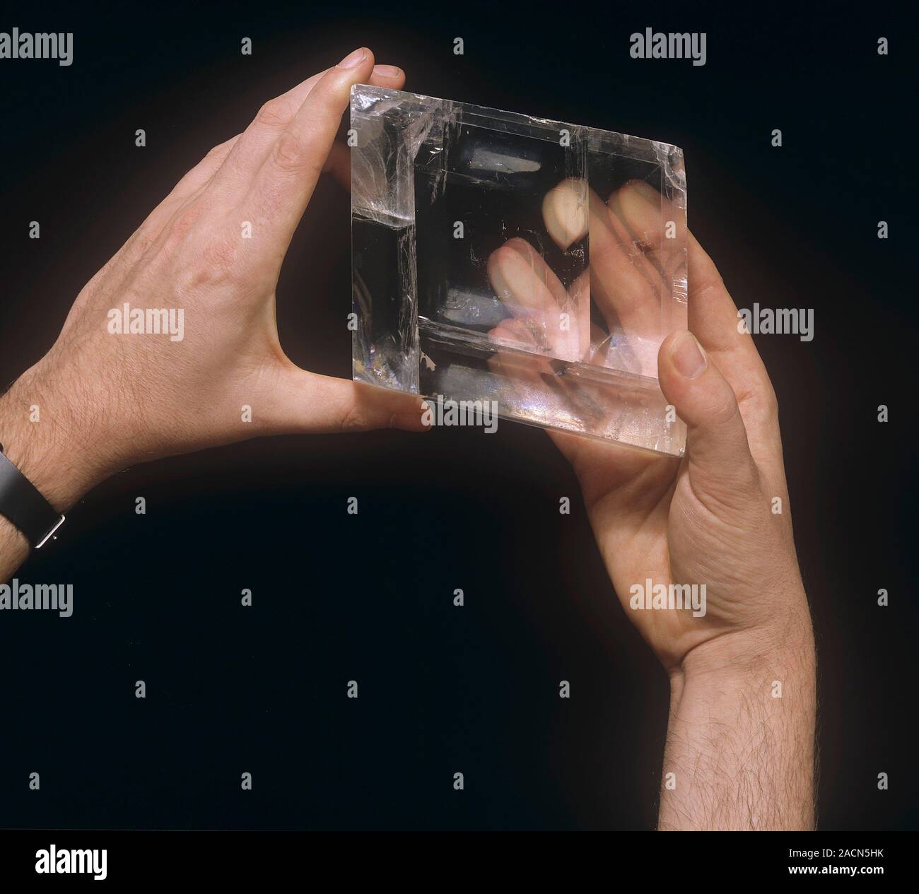 Double refraction (birefringrnce) in a calcite crystal. this phenomenon ...