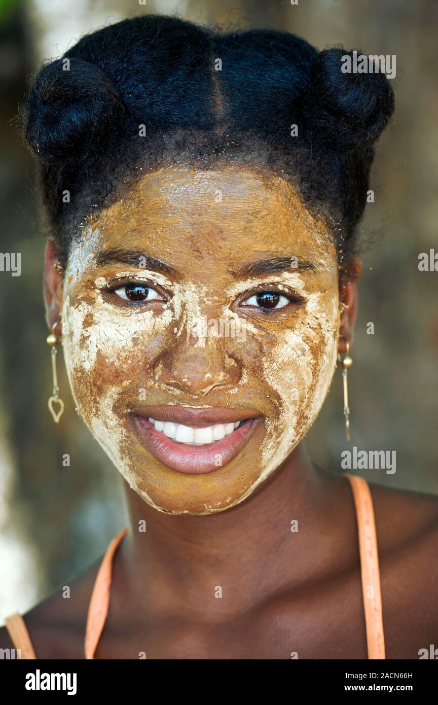 Malagasy woman. On her face is a paste made from the sandalwood shrub ...