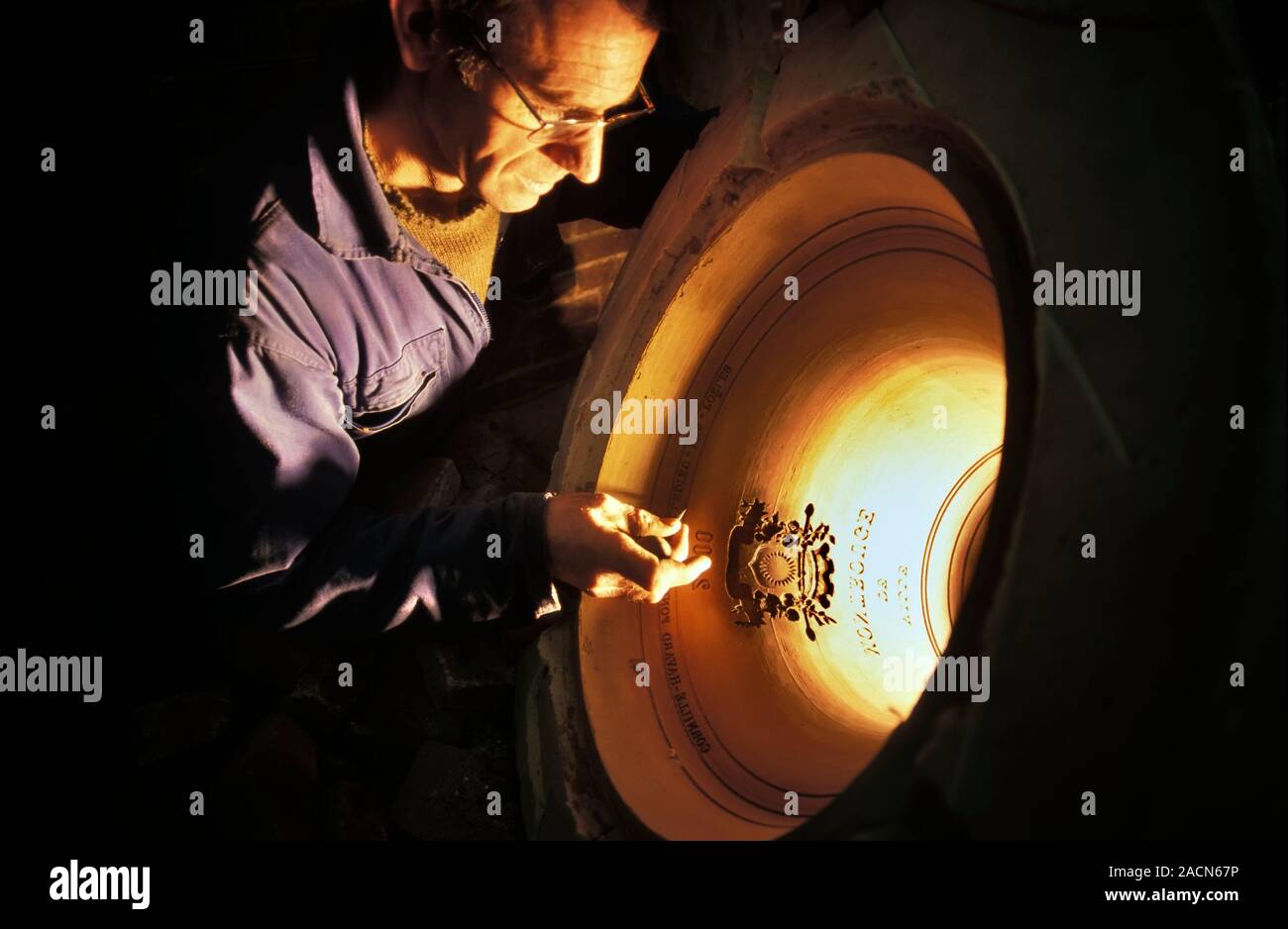 Bell-making. Bell founder manufacturing a mould that will be used to ...