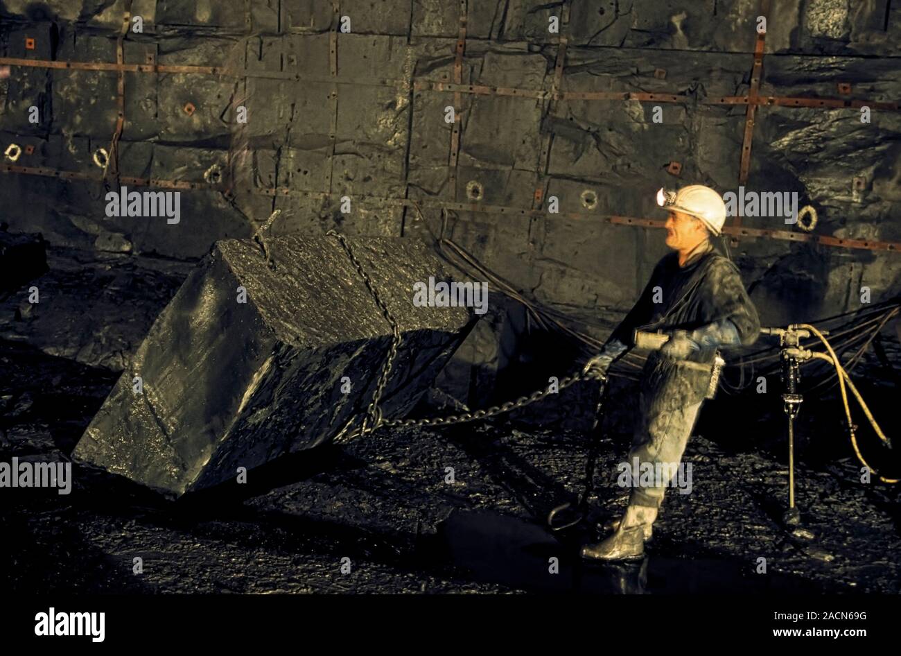 Slate mining. Worker with a large slab of slate that has been cut from ...