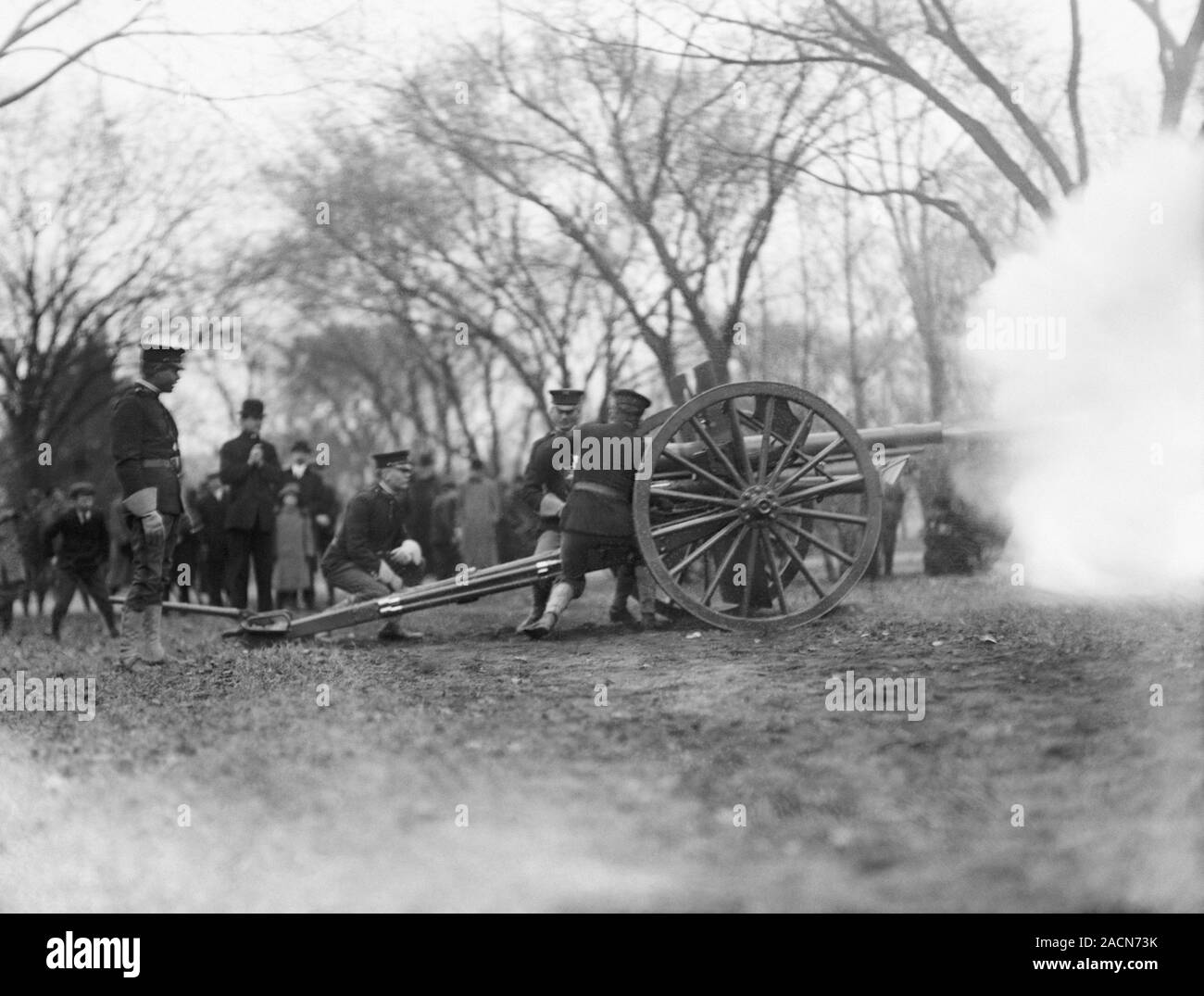 Cannon firing. Early twentieth century cannon being fired in a park ...