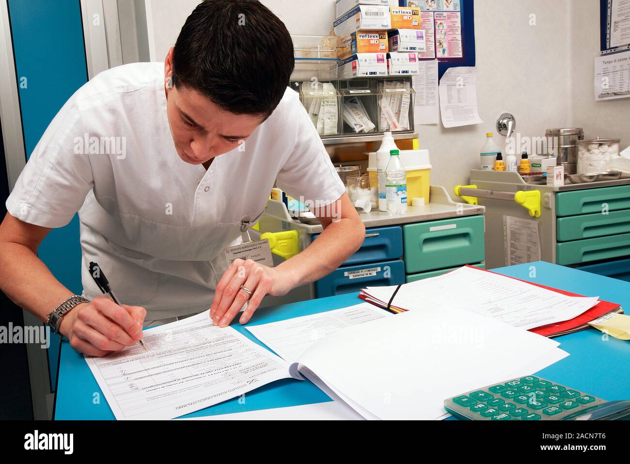 Obesity clinic. Nurse filling out paperwork Stock Photo - Alamy