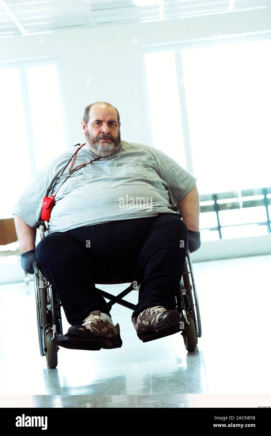 Obesity clinic. Male patient in a wheelchair Stock Photo - Alamy