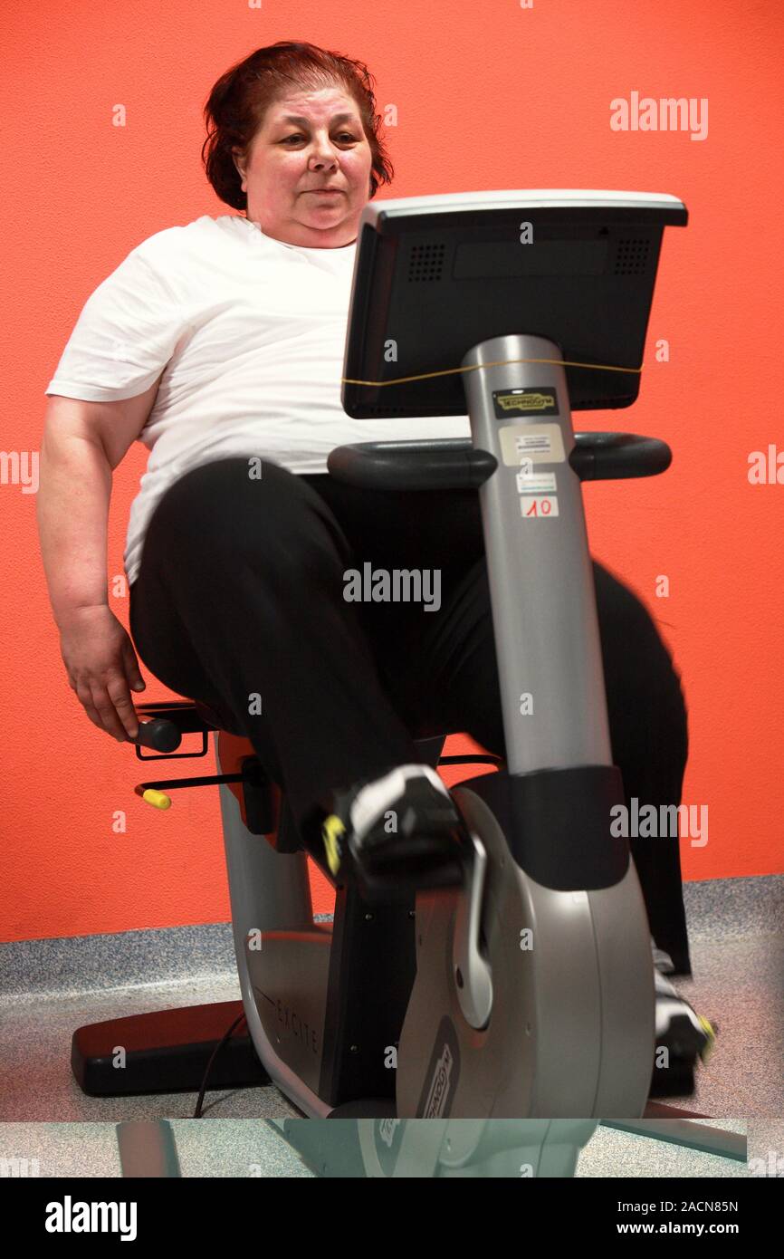 Obesity clinic. Female patient using an exercise bike Stock Photo - Alamy