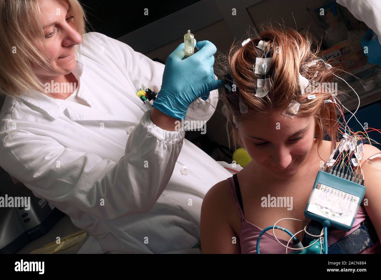 Electroencephalography. Neurologist placing electroencephalography (EEG ...