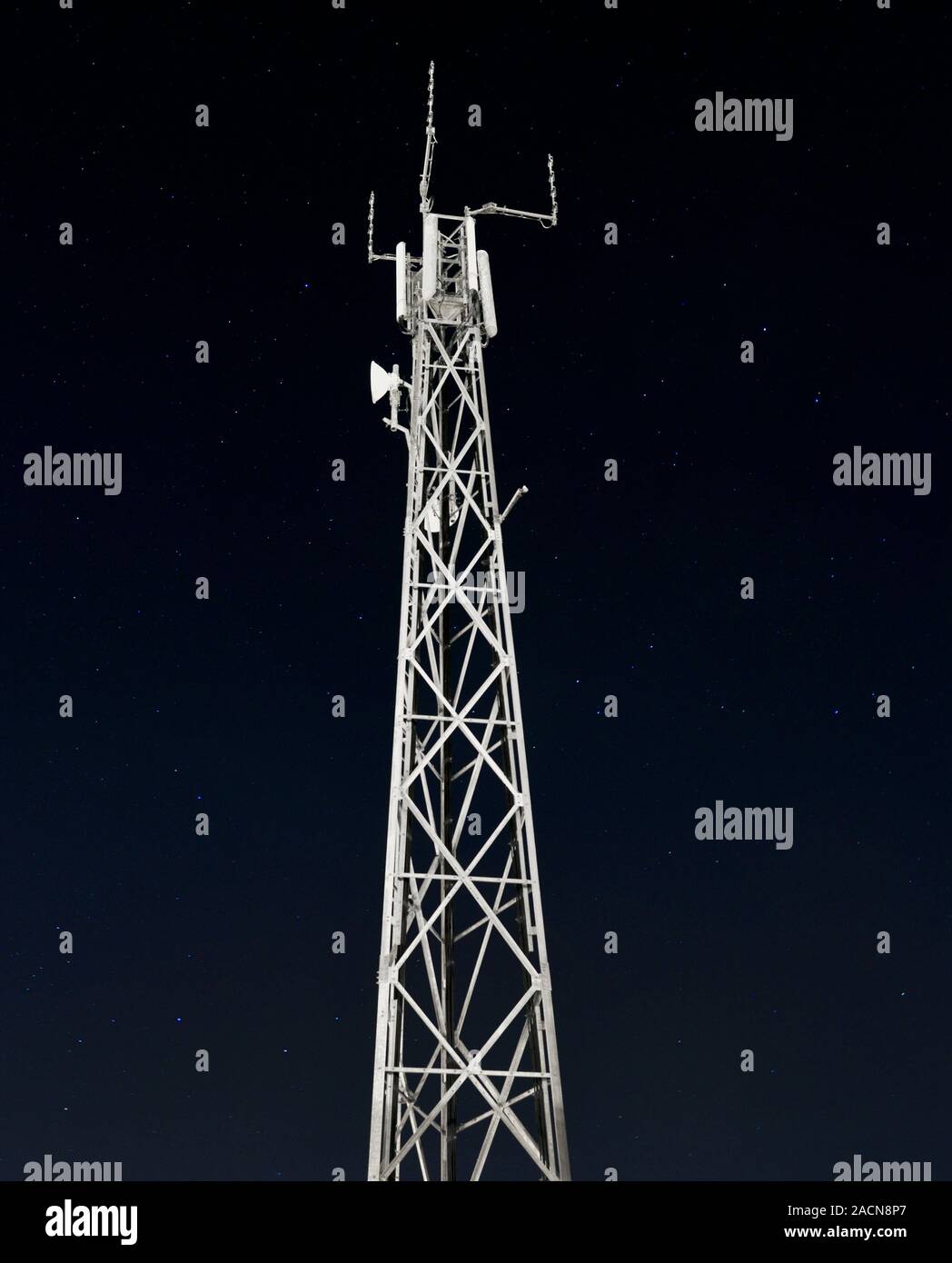 Telecommunications mast against clear night sky. Photographed in ...