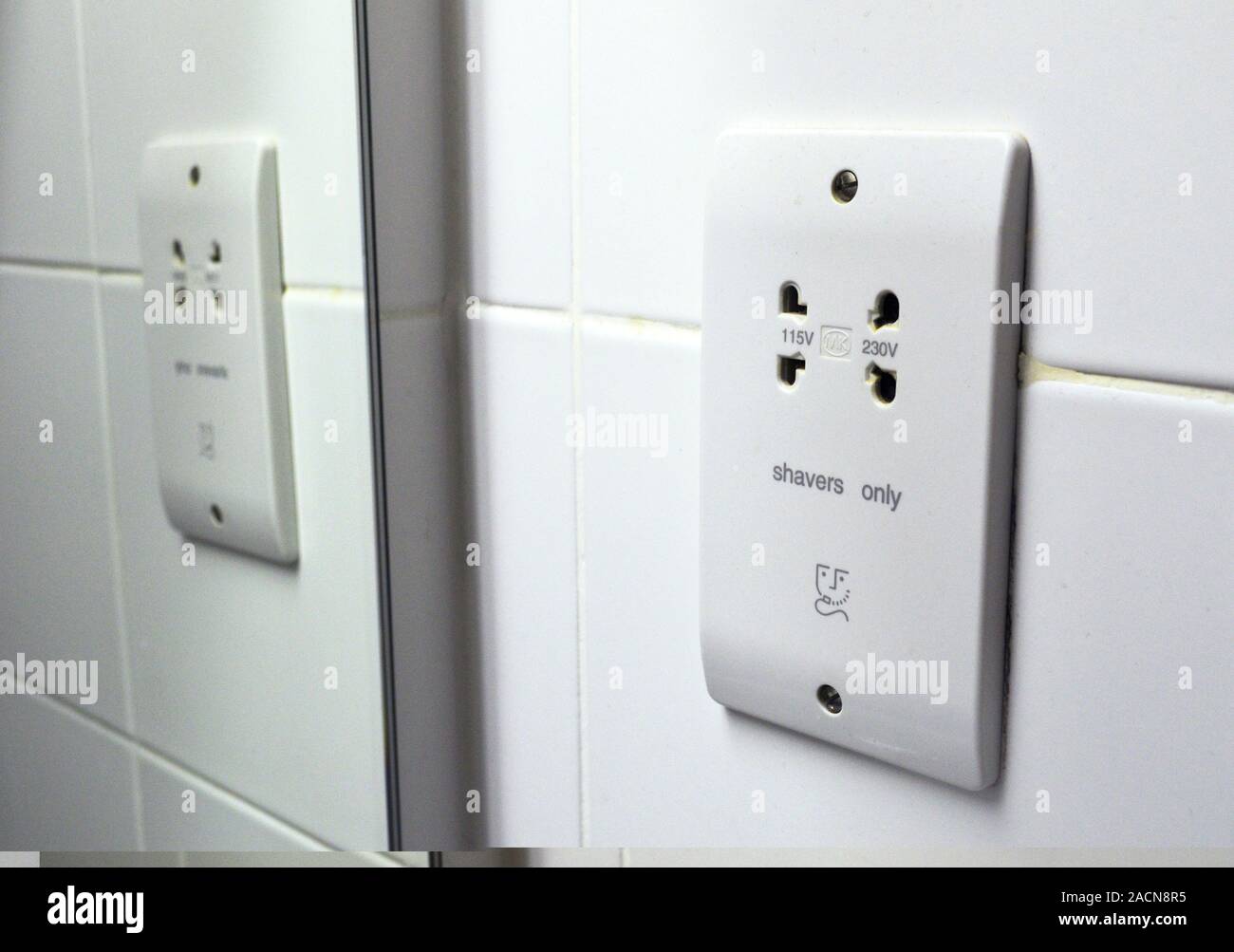 Dual voltage shaver point and its reflection in a mirror Stock Photo ...