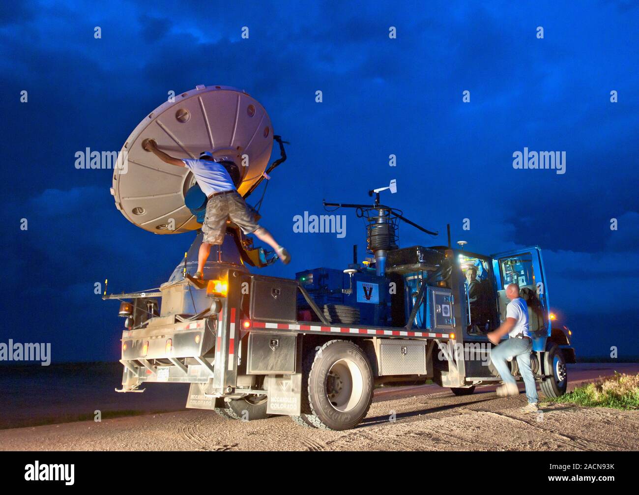 Storm chasing. Tornado researchers adjusting the dish on a Doppler on ...