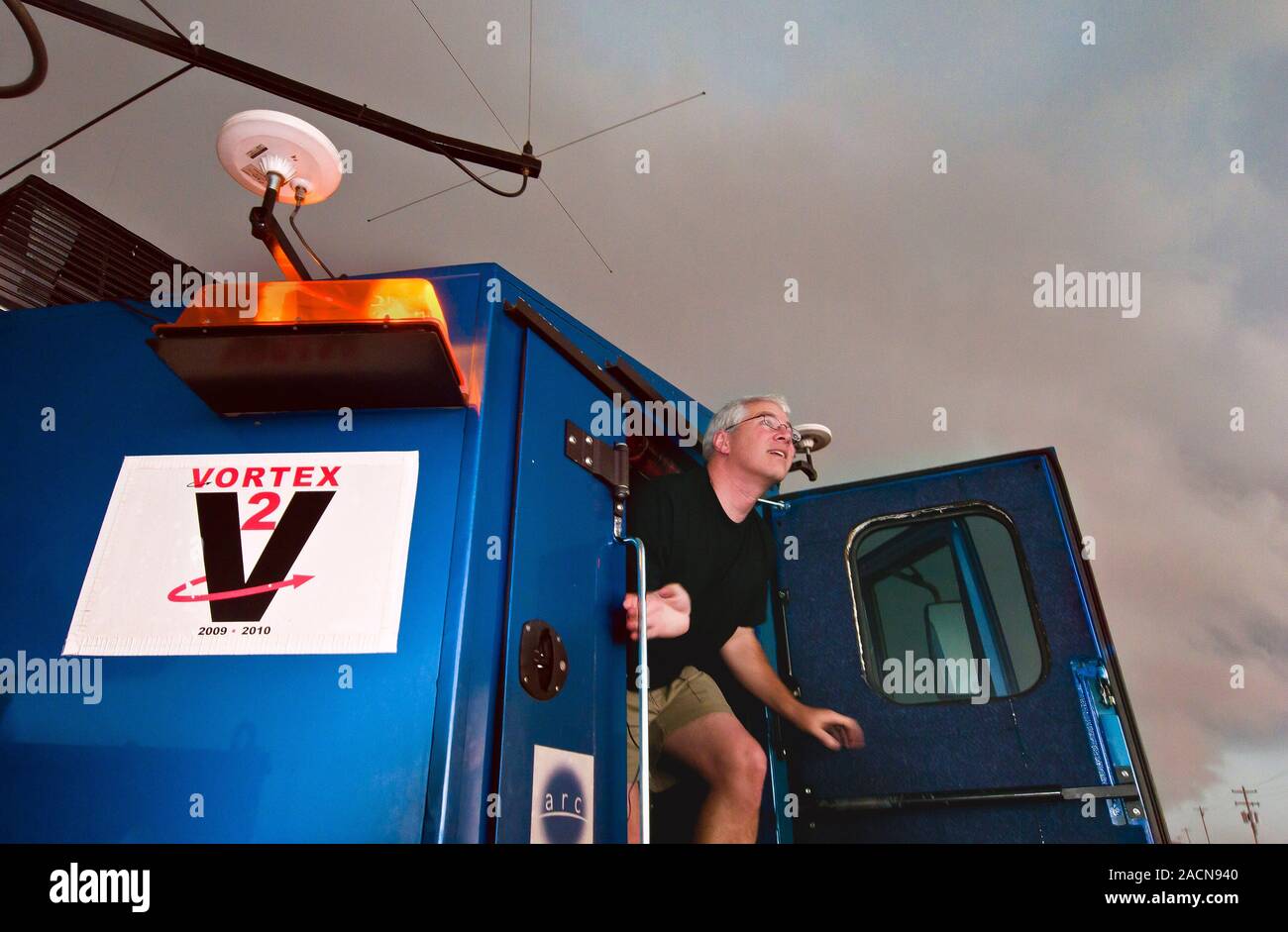 Storm chasing. Tornado researcher monitoring a severe thunderstorm from ...