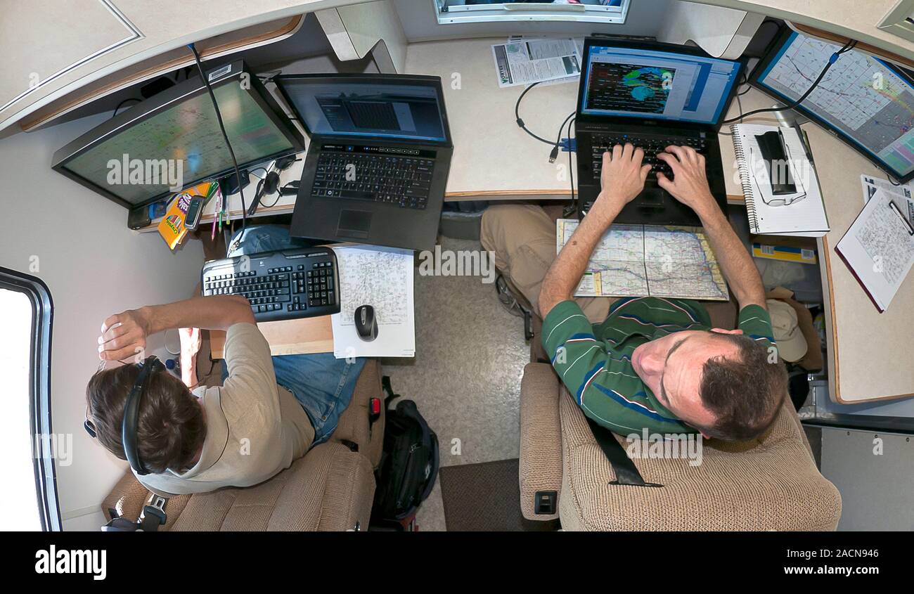 Storm chasing. Tornado researchers monitoring storms from inside the ...