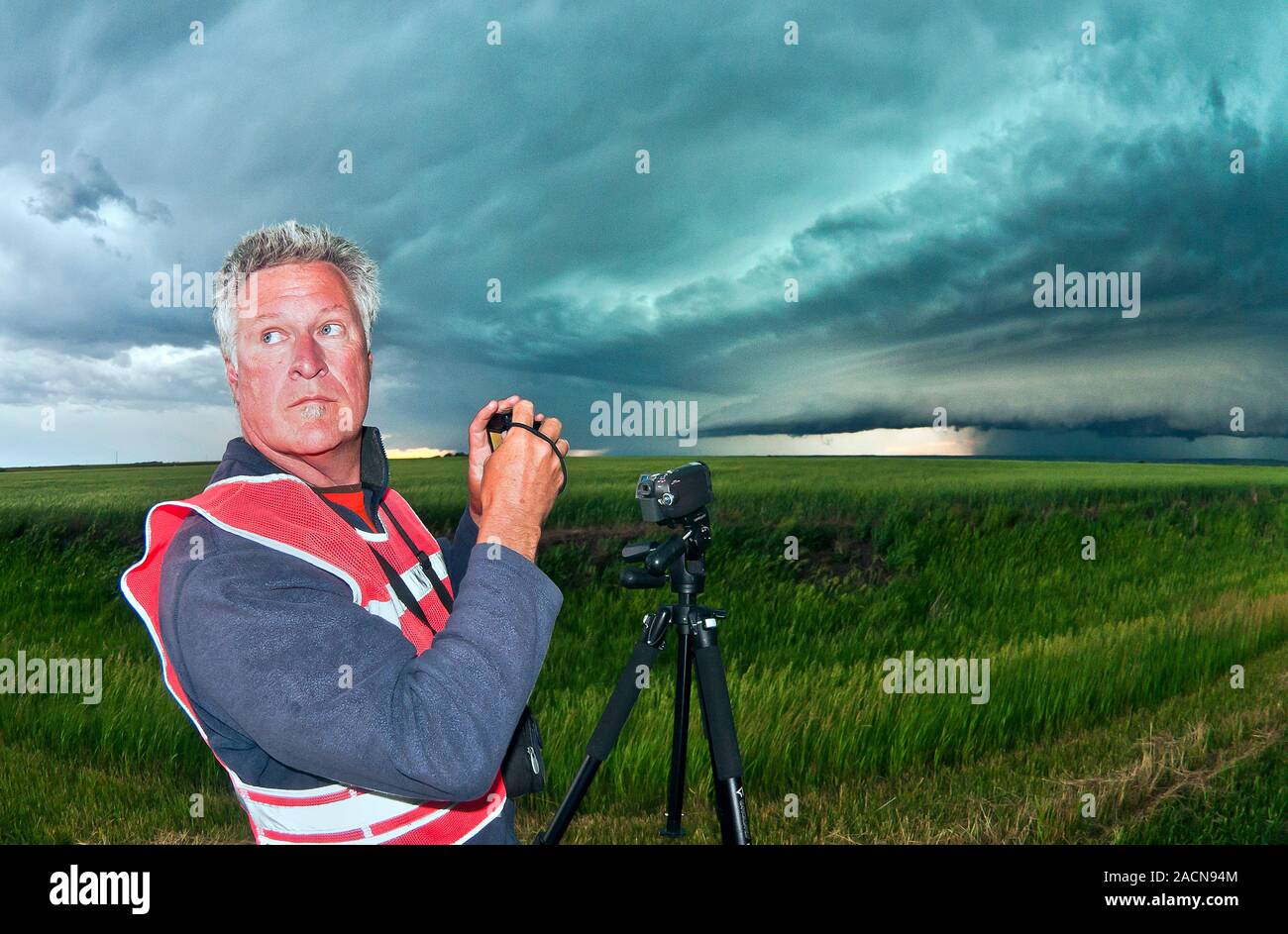 Storm chasing. Tornado researcher documenting an approaching supercell ...