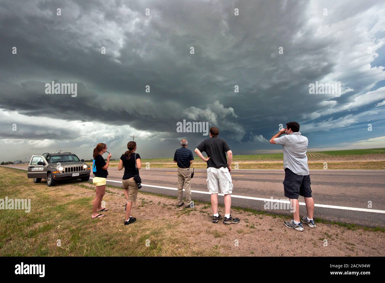 Storm chasing. Tornado researchers documenting an approaching supercell ...
