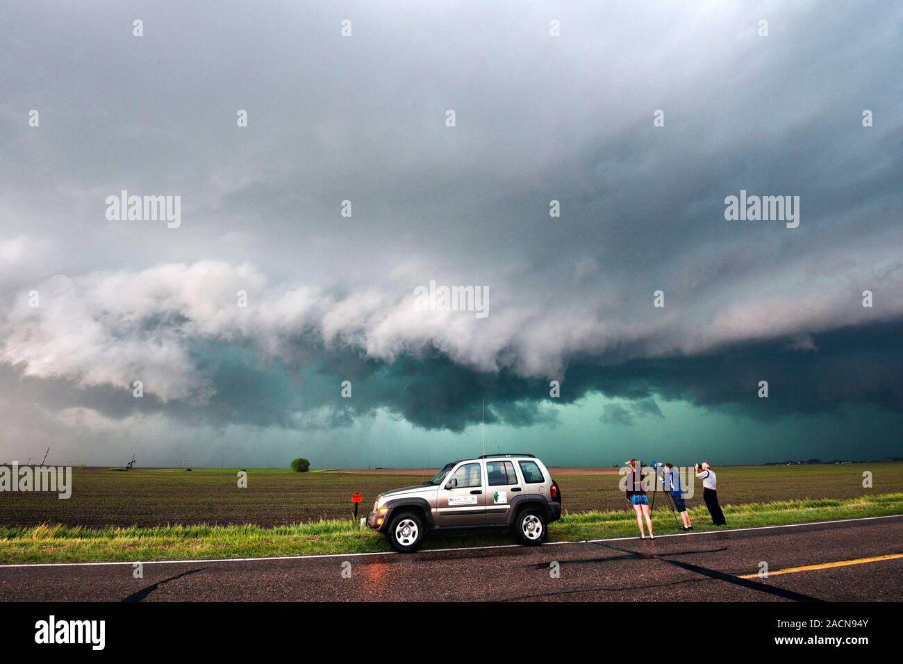 Storm chasing. Tornado researchers documenting an approaching supercell ...
