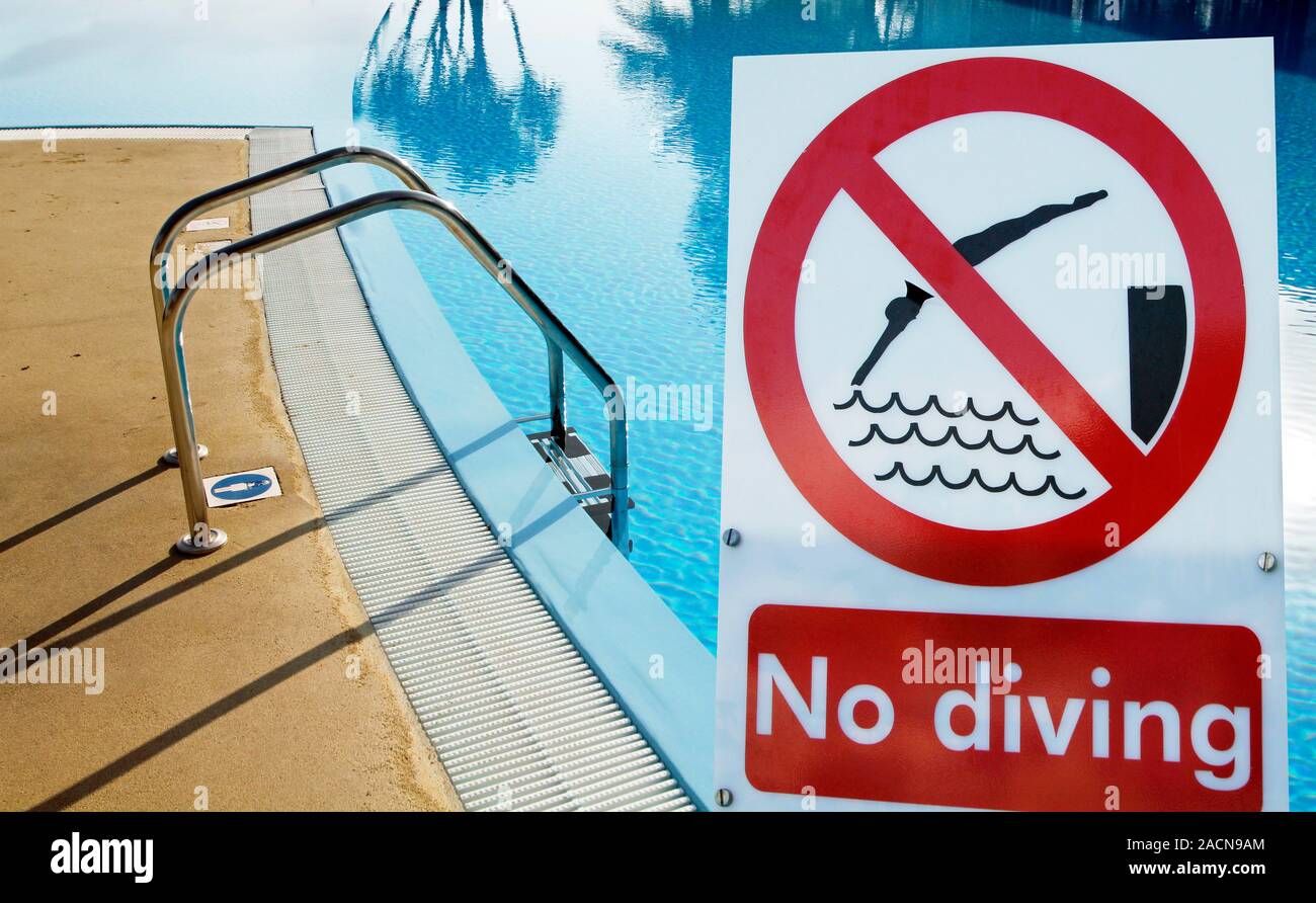No diving sign (right), with a shallow hotel swimming pool in the ...