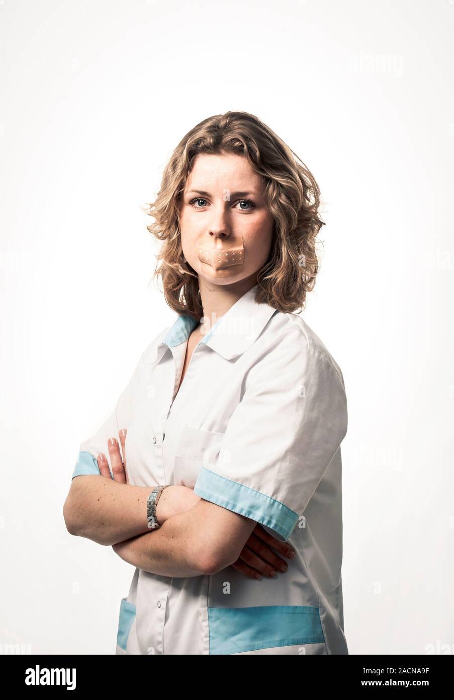 Medical confidentiality, conceptual image. Young nurse with a plaster ...