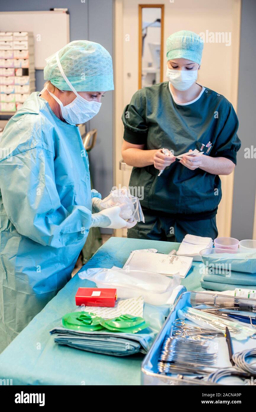 Surgical staff preparing for surgery. Surgical staff members preparing ...