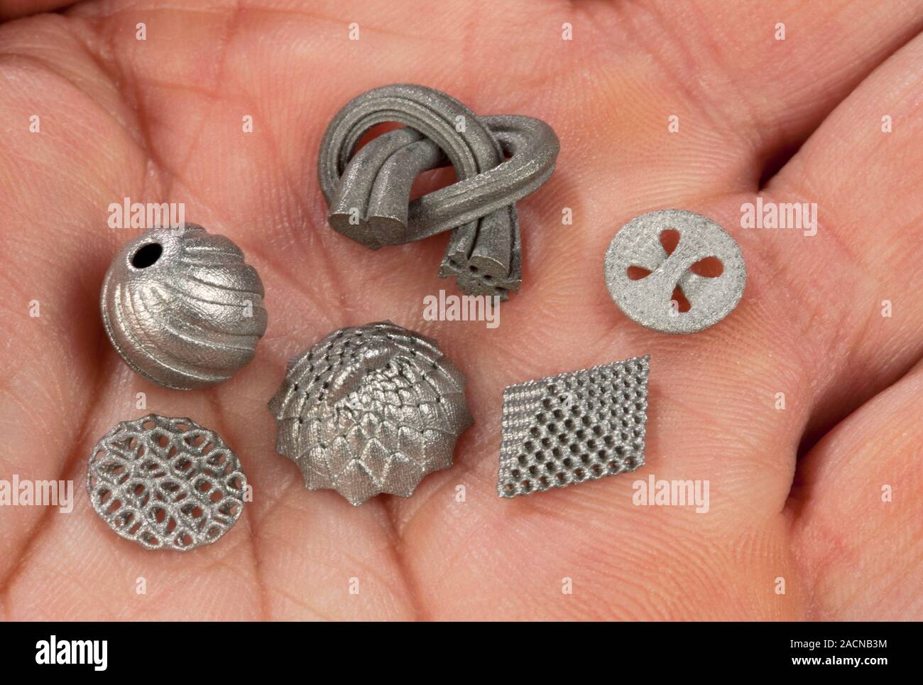 3D printed objects. Person holding small intricate objects made using ...