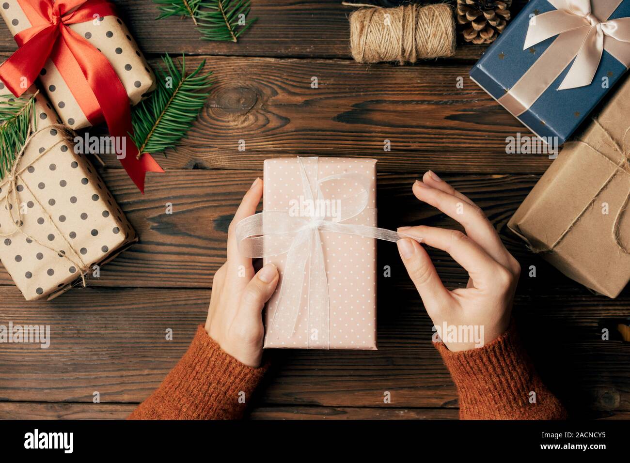 Female hands hold one box and untie the ribbon. Christmas concept Stock ...