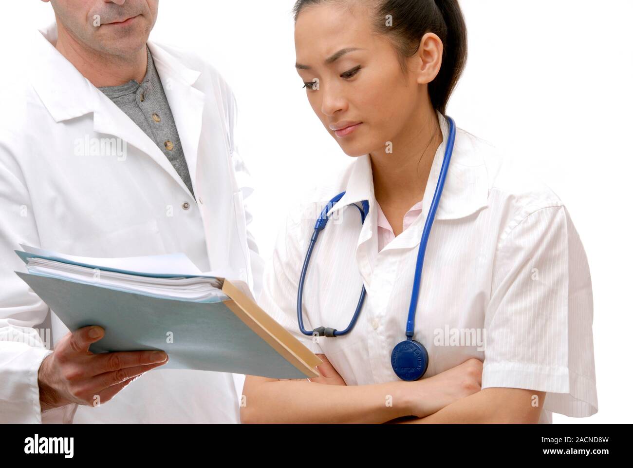 Doctors with patient records Stock Photo - Alamy
