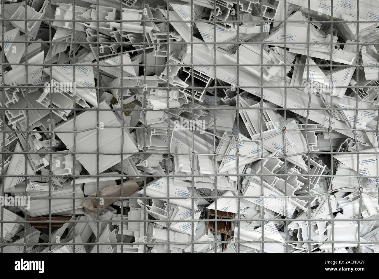 Scrapped uPVC window frames for recycling. uPVC is unplasticized ...