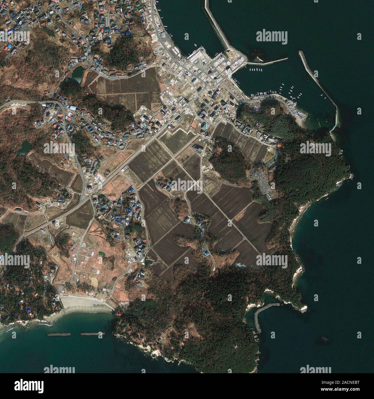 Sendai post-tsunami. Satellite image showing the eastern coast of ...