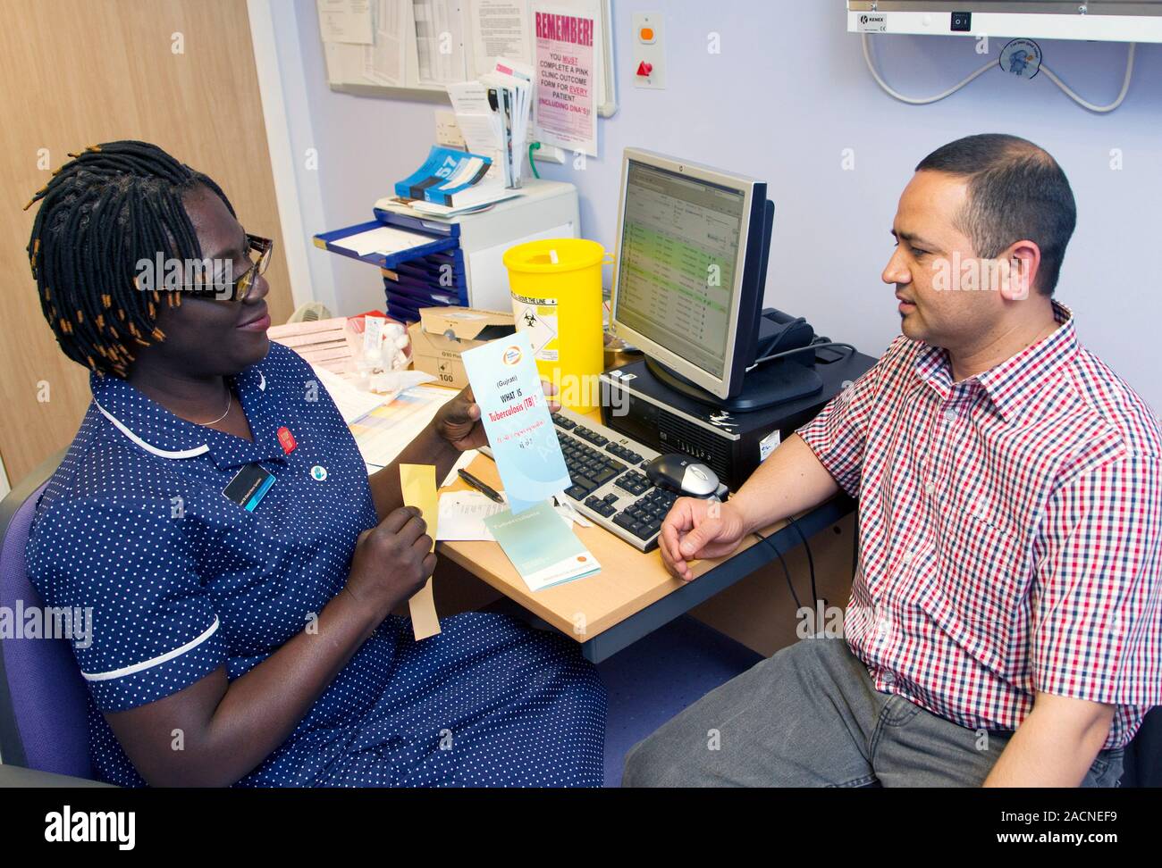 Tuberculosis (TB) clinic consultation. Nurse providing an information ...