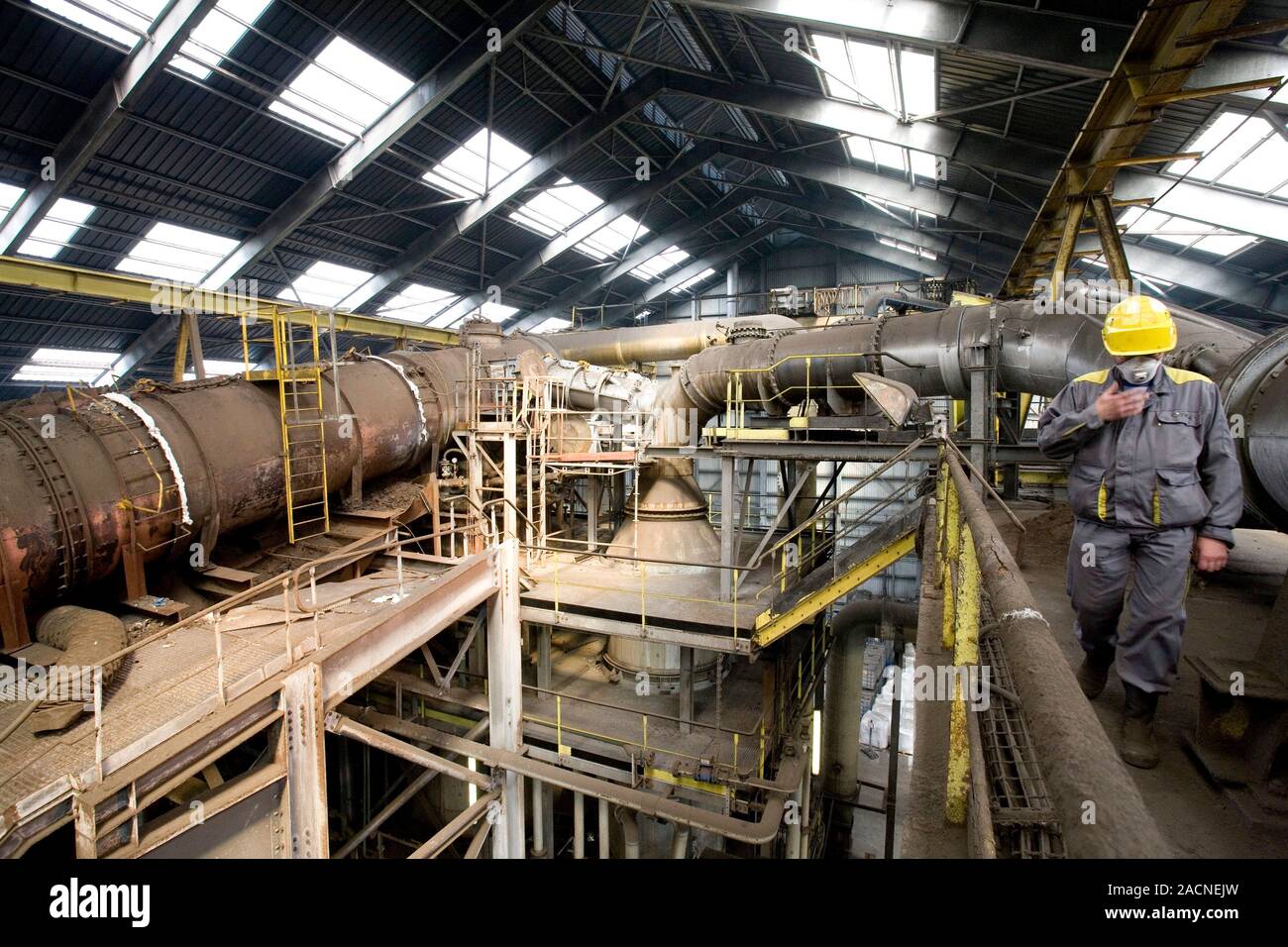 Heavy metals recycling factory. Worker inside a factory that ...