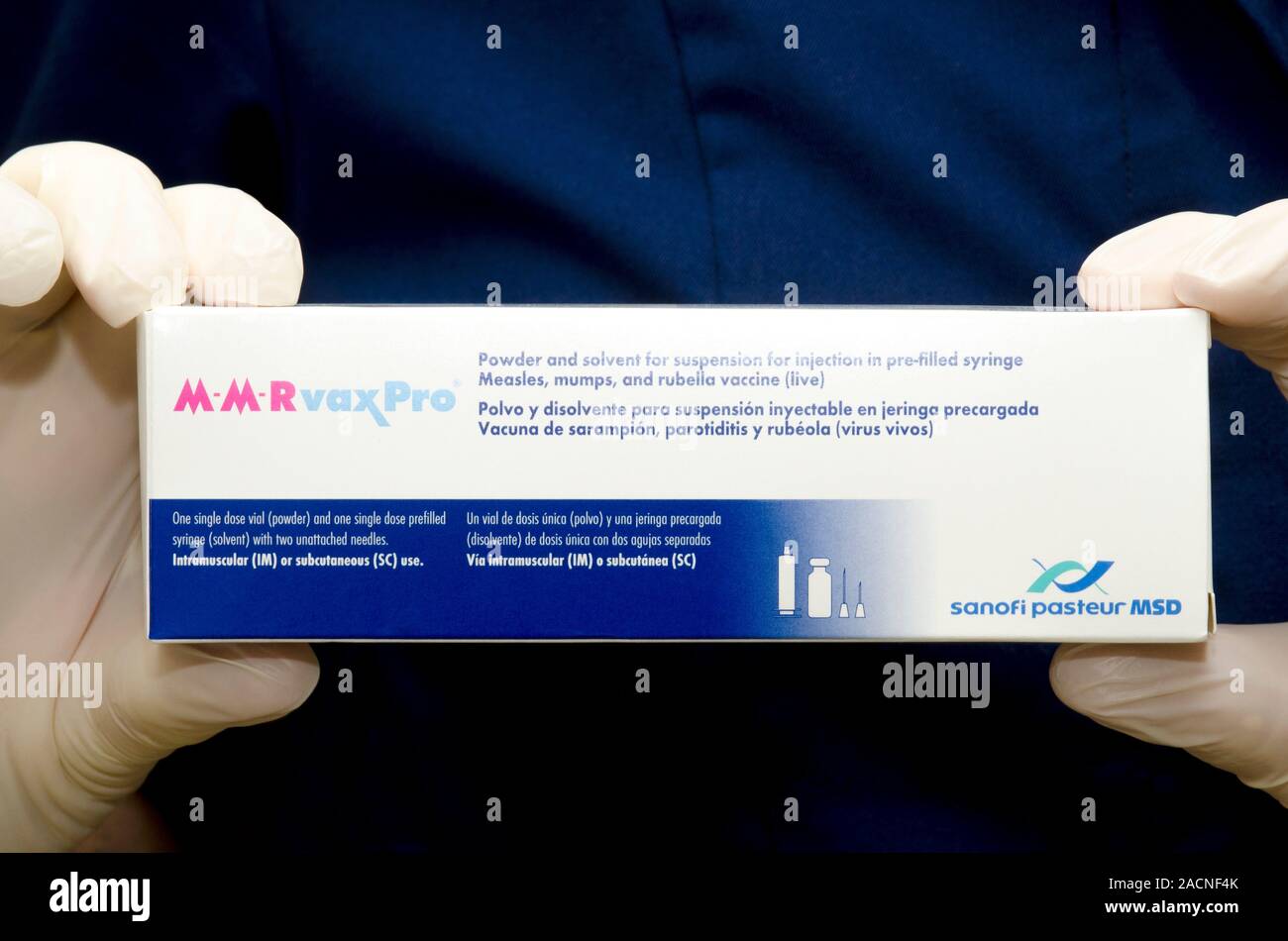 MMR vaccine. Health worker holding a box containing MMR vaccine for ...