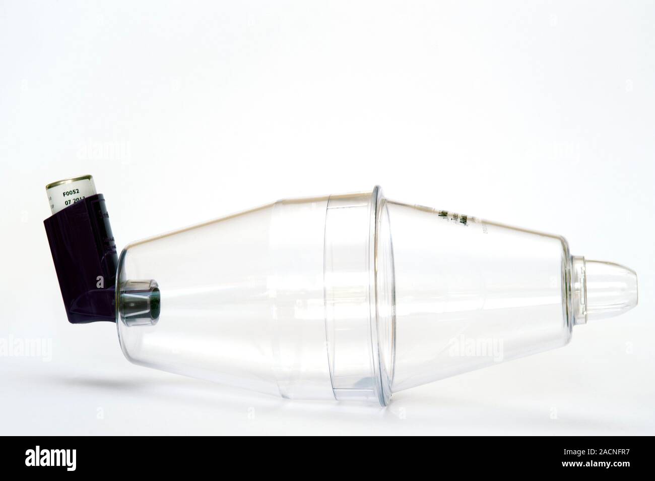 Seretide inhaler (at left) with a spacer device used to treat asthma ...