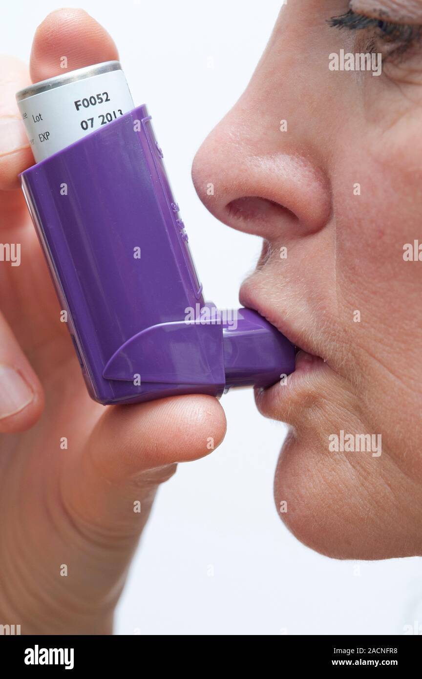 Adult female patient uses a Seretide inhaler to treat asthma or COPD. This seretide inhaler ...