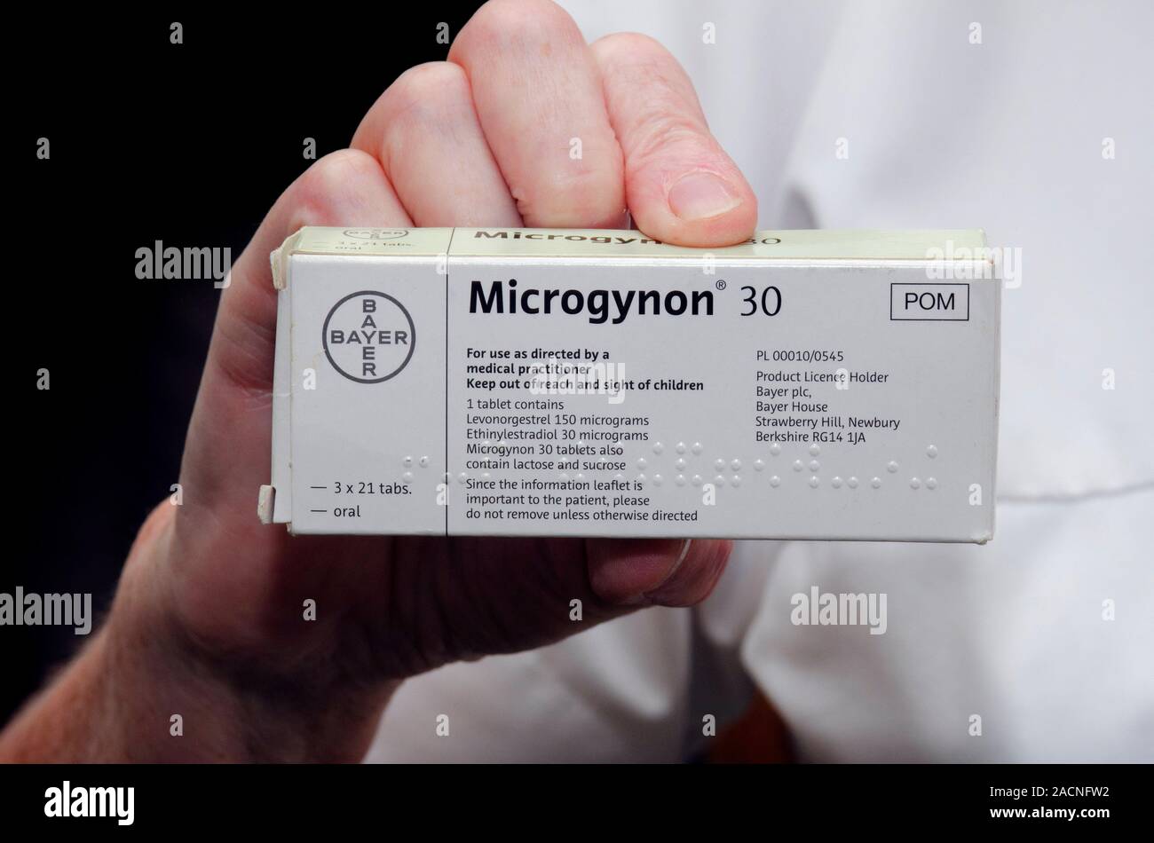 Hand holds a pack of Microgynon 30 pills, an oral contraceptive taken by women to suppress ...