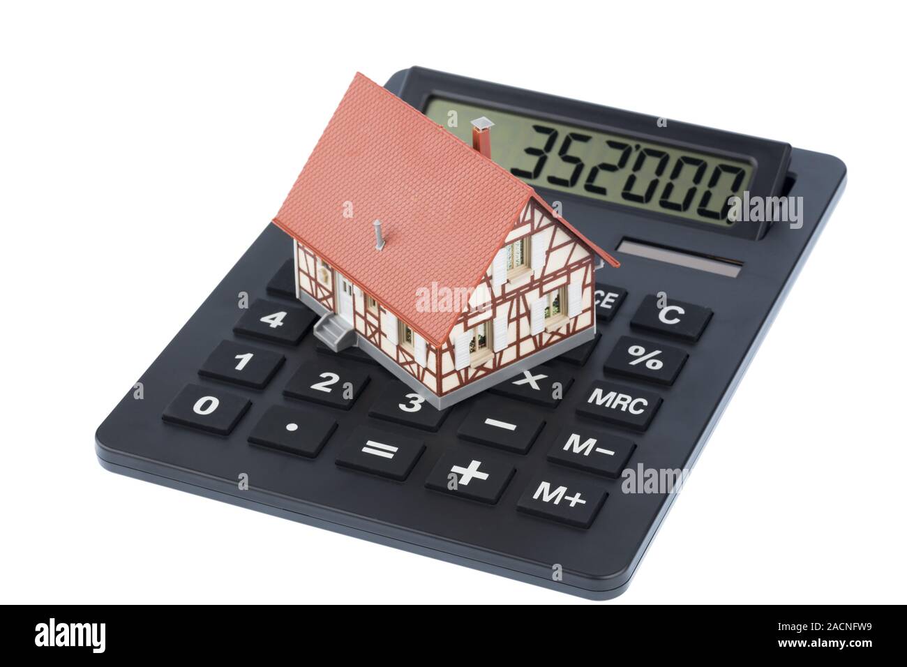 Residential house on calculator Stock Photo - Alamy