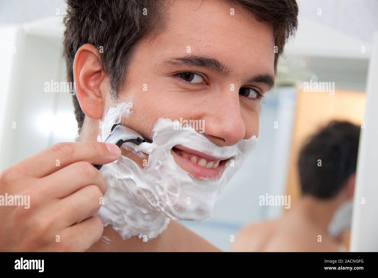 Man shaves with razor blade and shaving show Stock Photo - Alamy