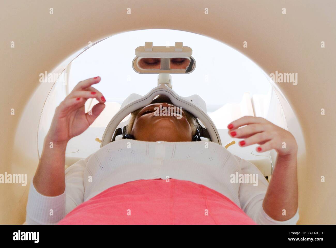 Hypnosis research. Woman undergoing an MRI (magnetic resonance imaging ...