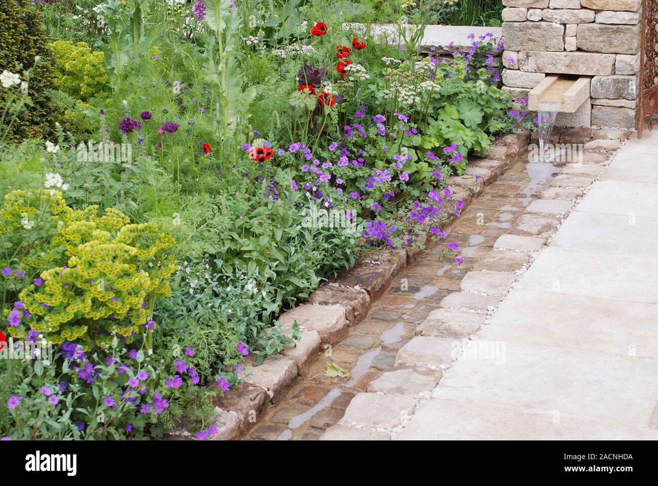 Garden exhibition water feature. Display of flowering plants at a ...