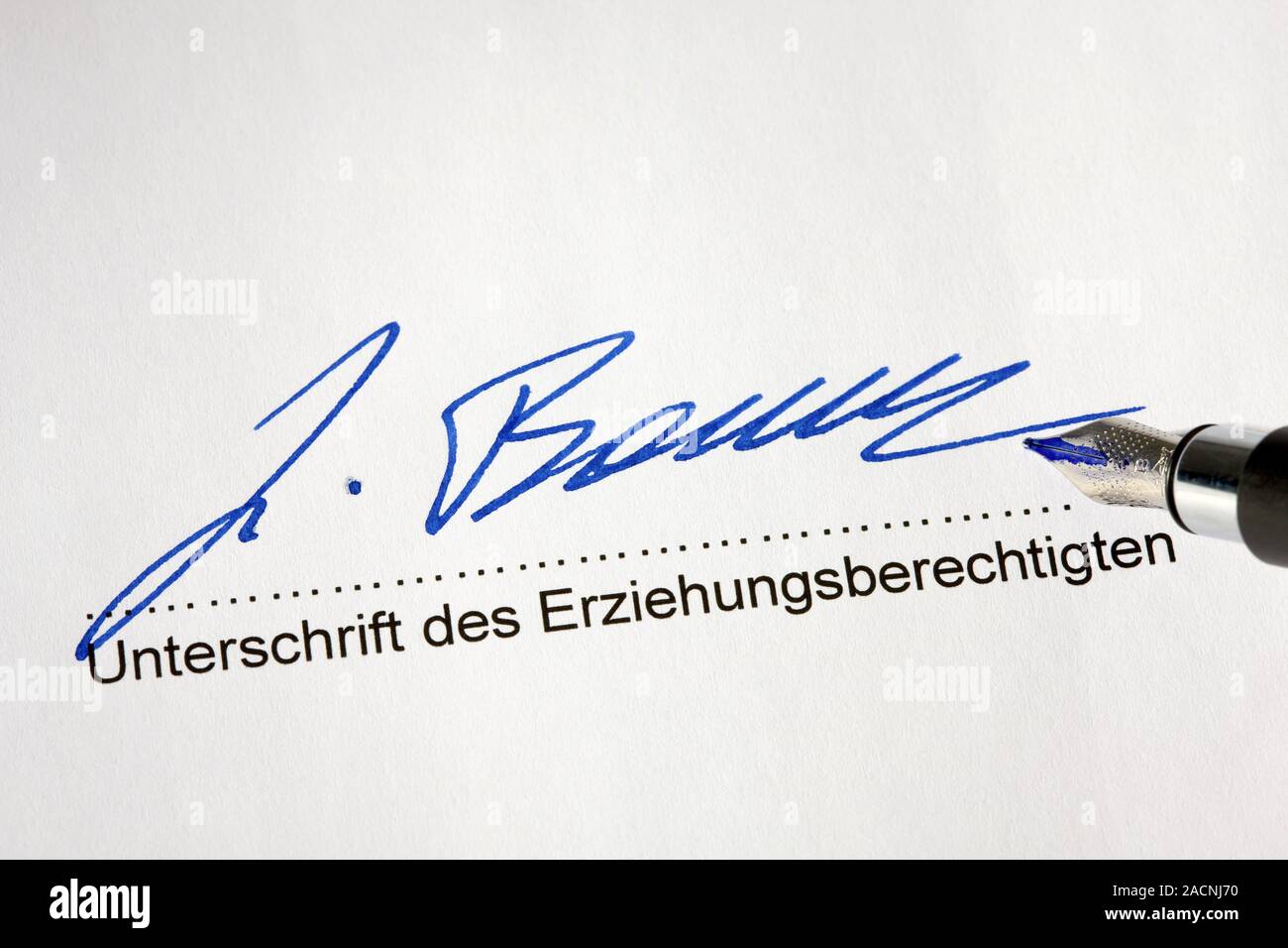 Signing a school document Stock Photo - Alamy