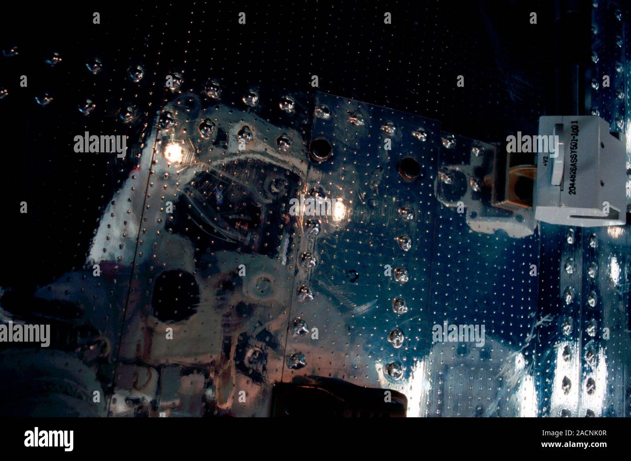 Astronaut reflection on a panel of the Hubble Space Telescope ...