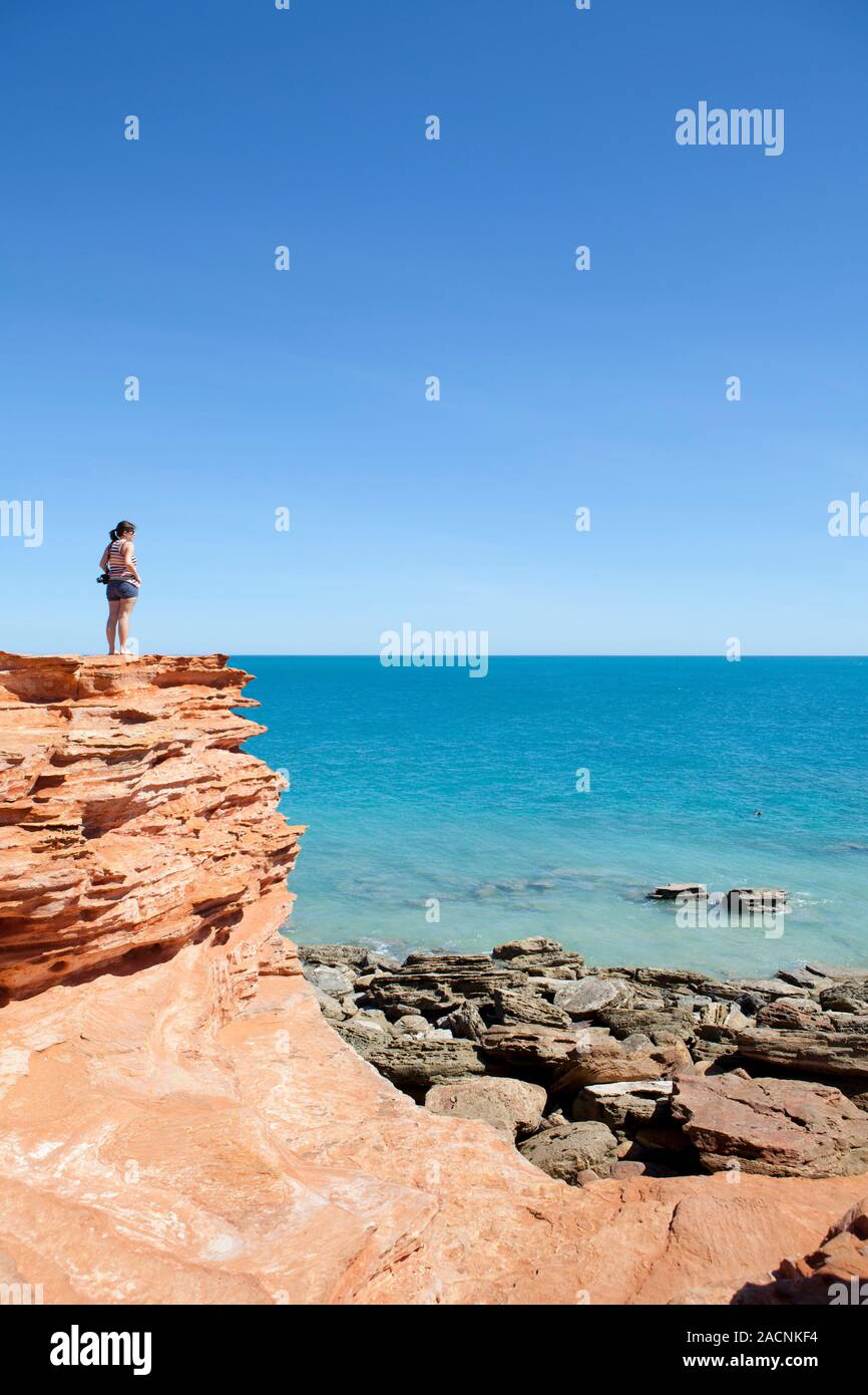 Woman stands atop Broome sandstone formations at Gantheaume Point Stock ...
