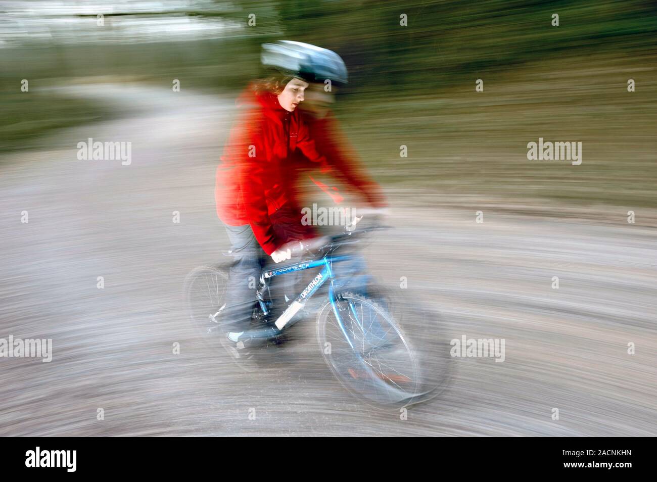 Teenage boy riding a bike at speed Stock Photo - Alamy