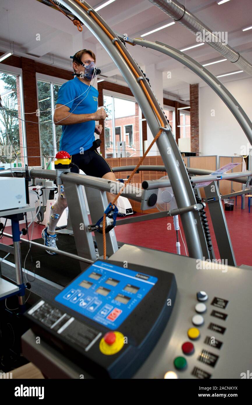 Fitness testing. Athlete running on a treadmill while his oxygen ...