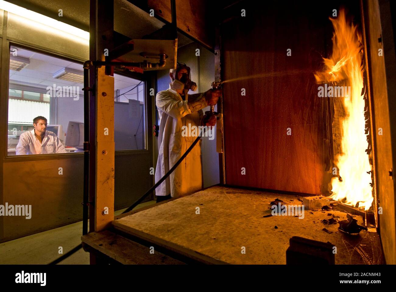 Fire resistance testing. Workers testing the fire resistance of a ...