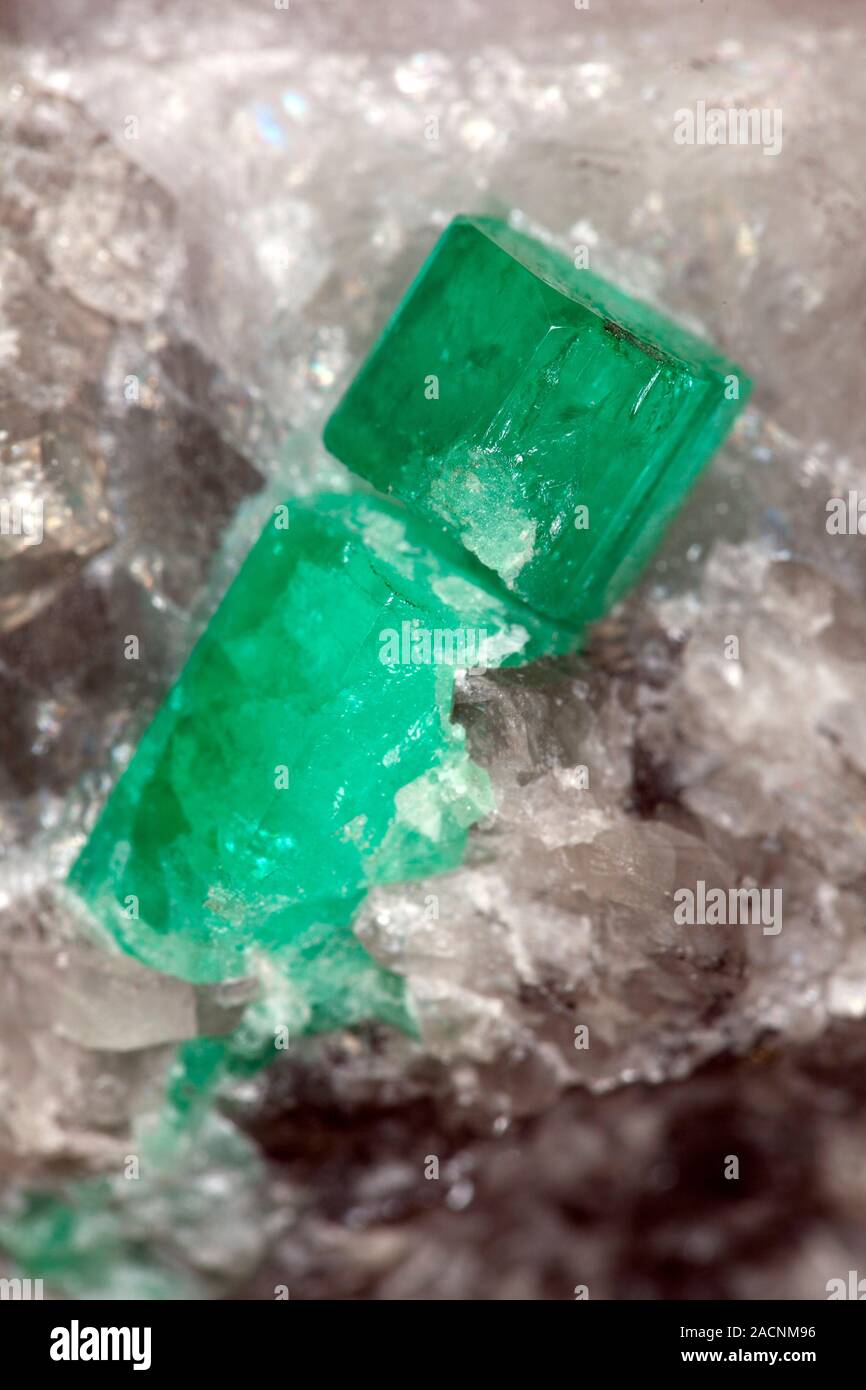 Emerald in quartz. Close-up of an emerald (green) amongst quartz ...