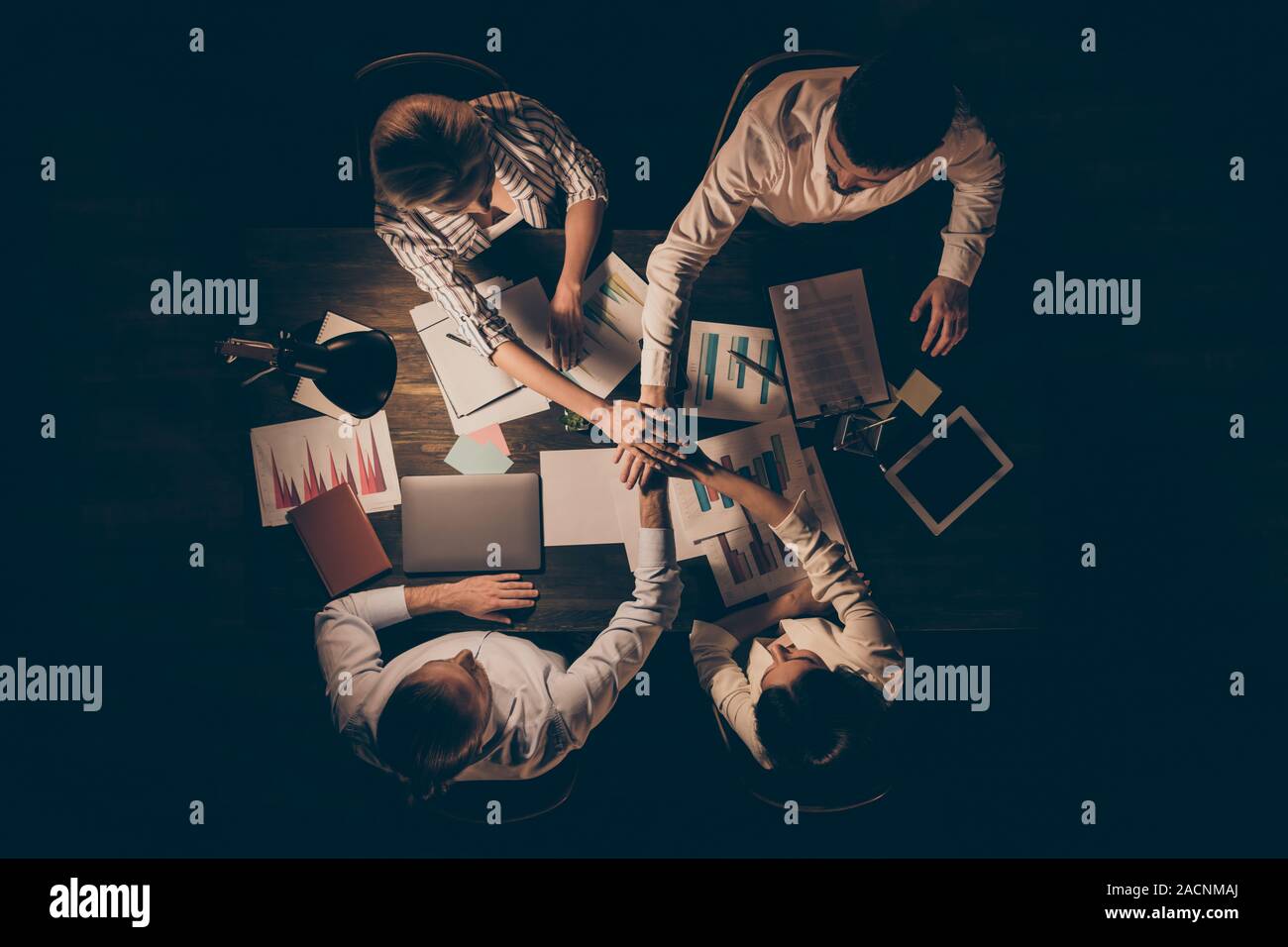 High angle above view photo of four business partners sitting opposite ...