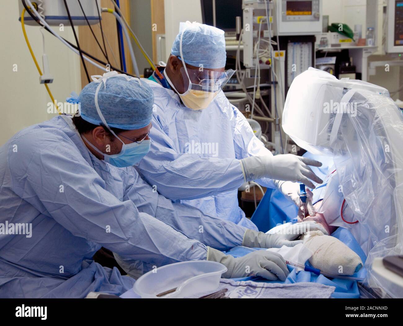 Arm fracture surgery. Surgeons operating on a patient during surgery to ...
