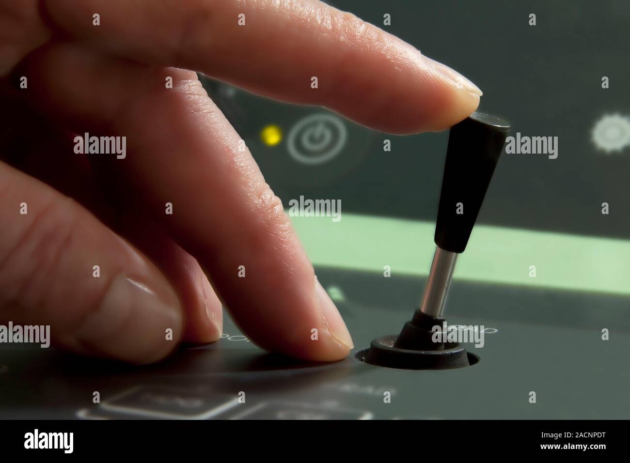 Container ship controls. Close-up of a worker operating a tiny joystick ...
