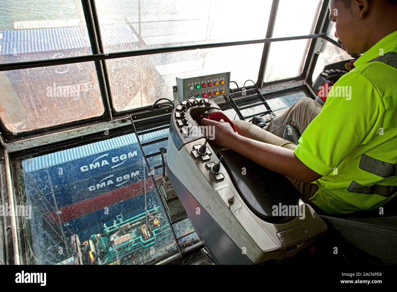Container crane operator. Worker inside the cabin of a container ...